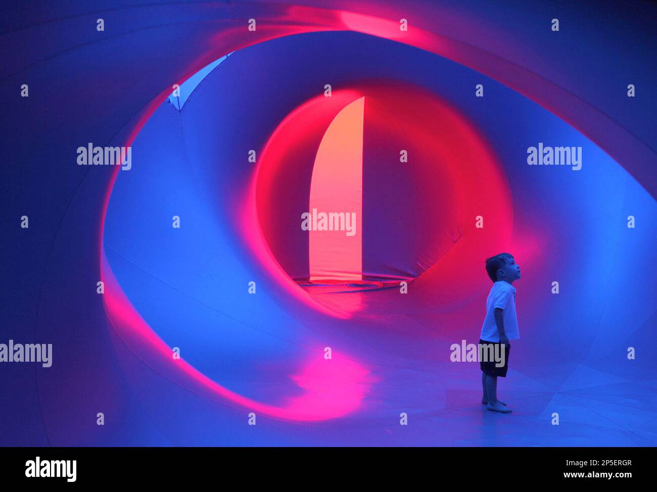 A child looks up at the light inside Exxopolis, Architects of Air's ...
