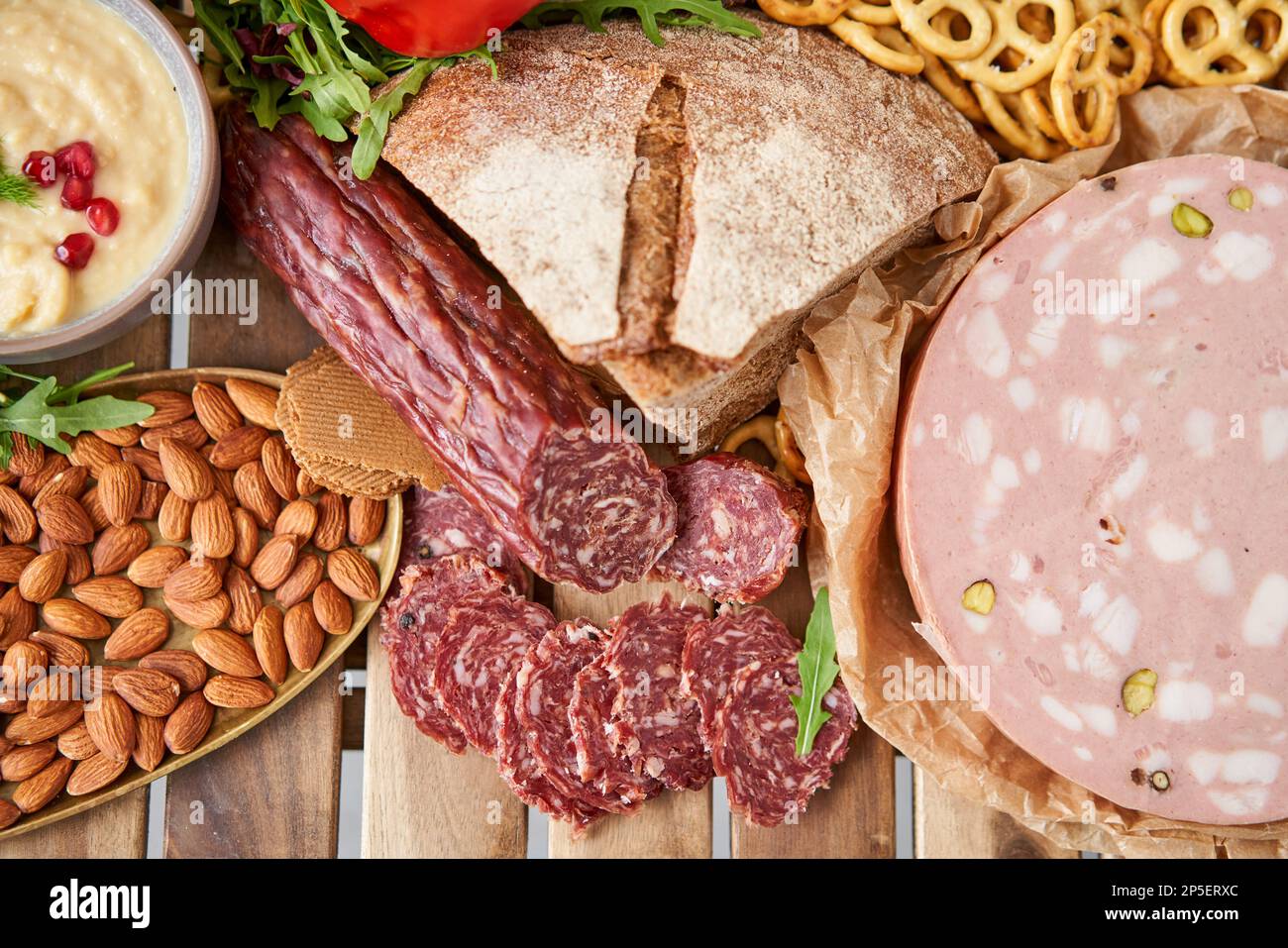 Salami sausage close-up. Table full of mediterranean appetizers, tapas ...