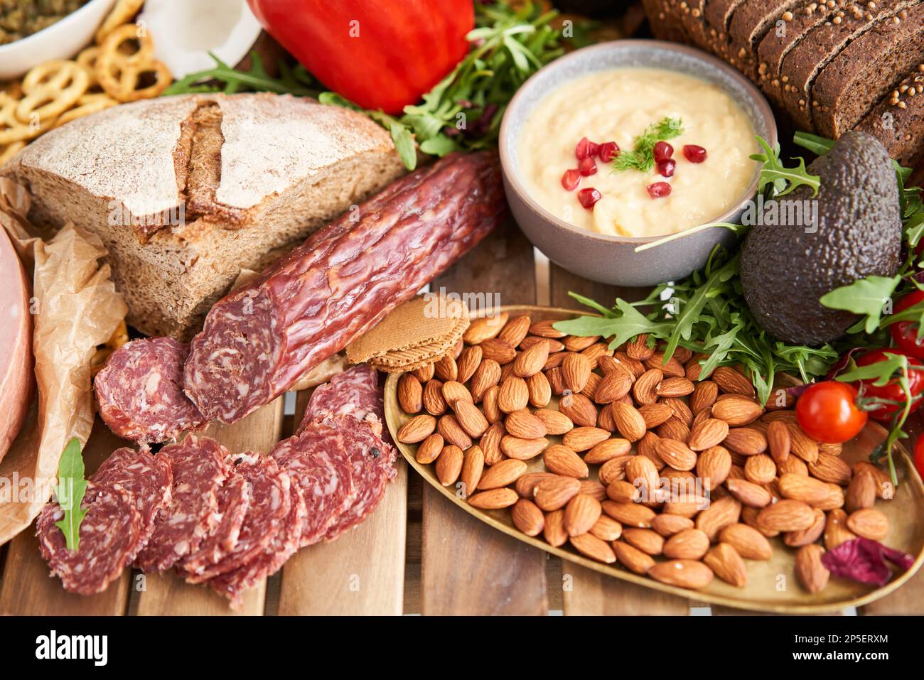 Salami sausage close-up. Table full of mediterranean appetizers, tapas ...