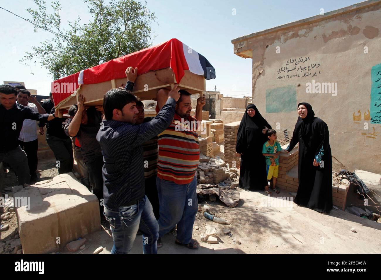 A bombing victim, Bashar Muhsin, 28, is taken for burial in Najaf, 100 ...