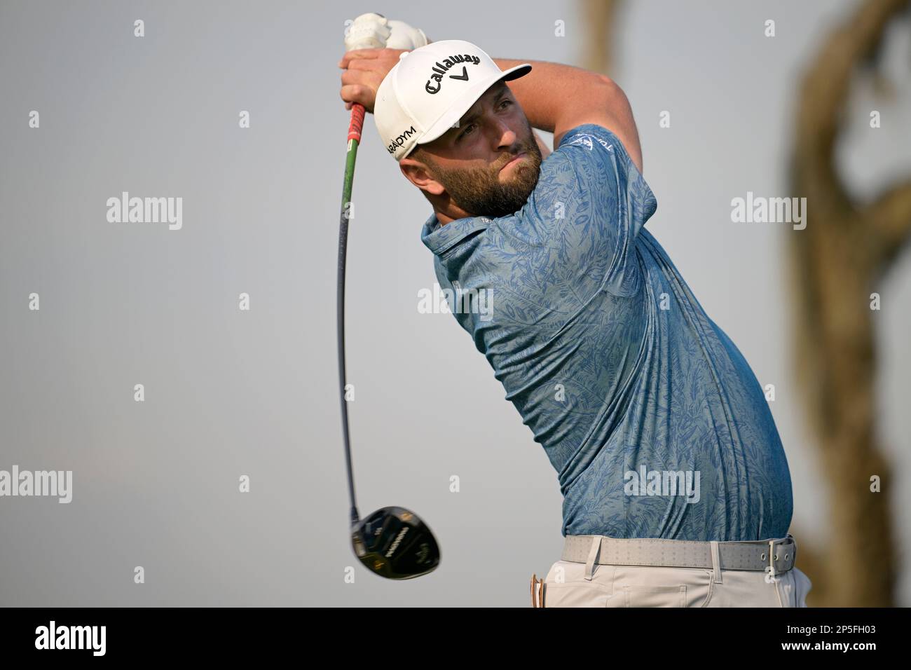 Jon Rahm, of Spain, watches after hitting his tee shot on the 15th hole ...