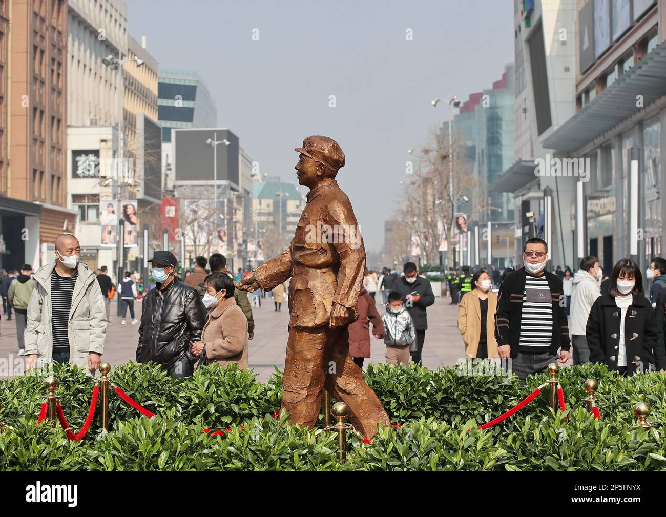 People take photos in front of the bronze statue of Lei Feng, a Chinese ...