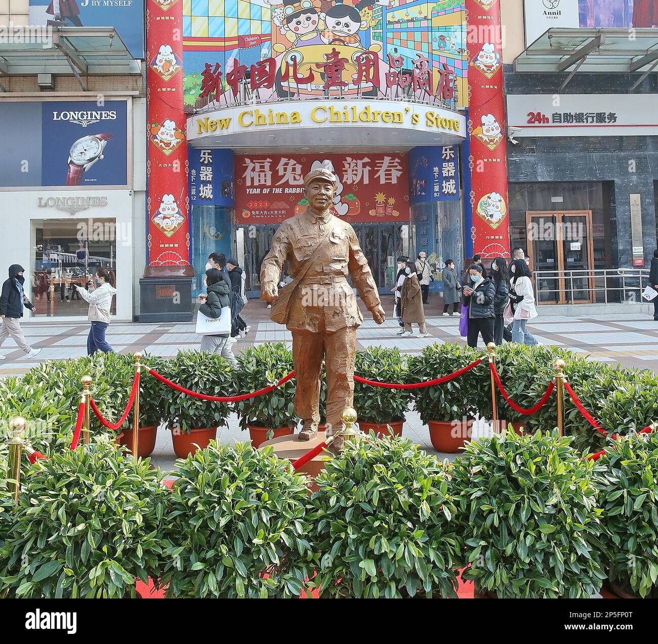 People take photos in front of the bronze statue of Lei Feng, a Chinese ...
