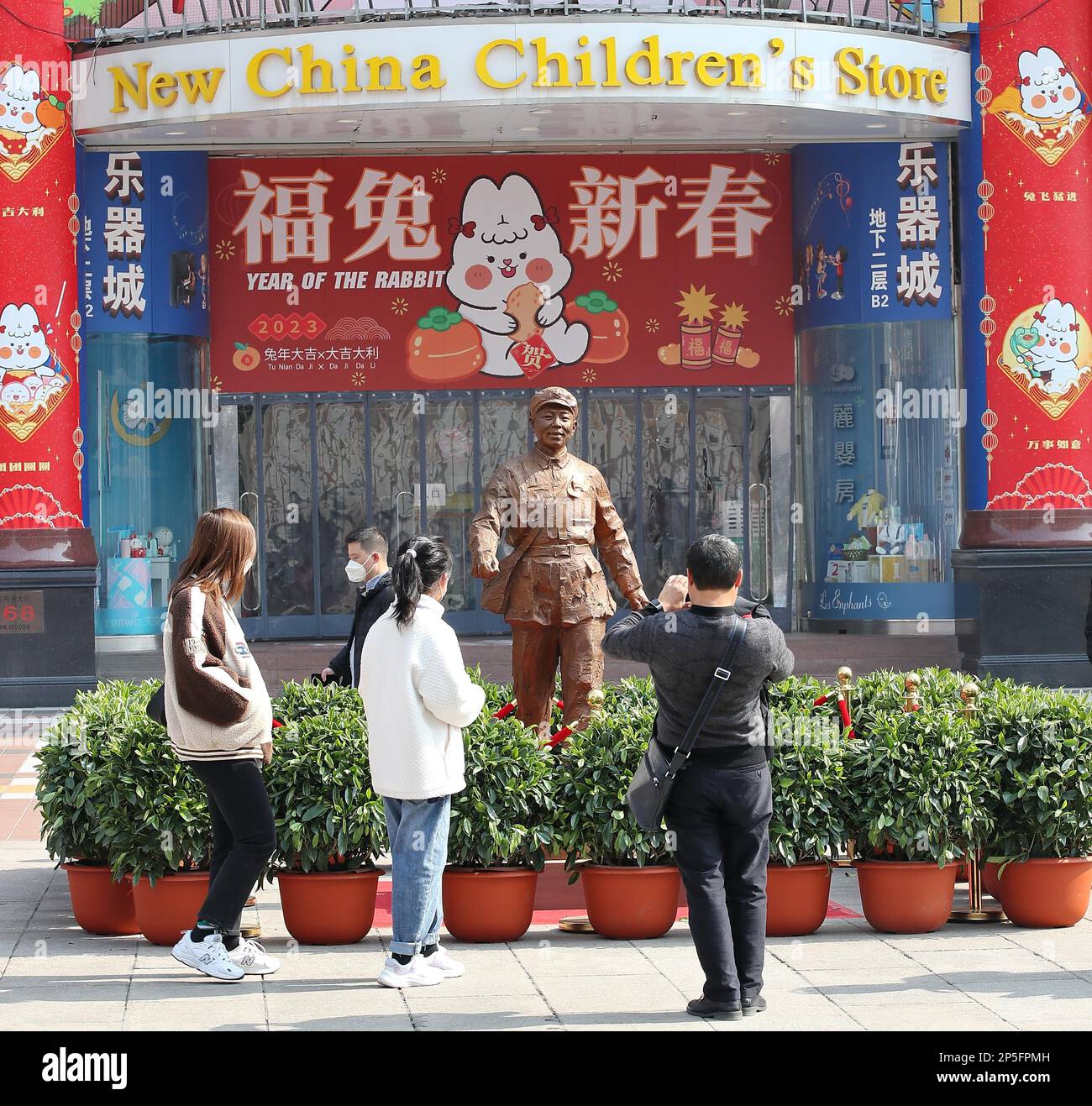 People take photos in front of the bronze statue of Lei Feng, a Chinese ...