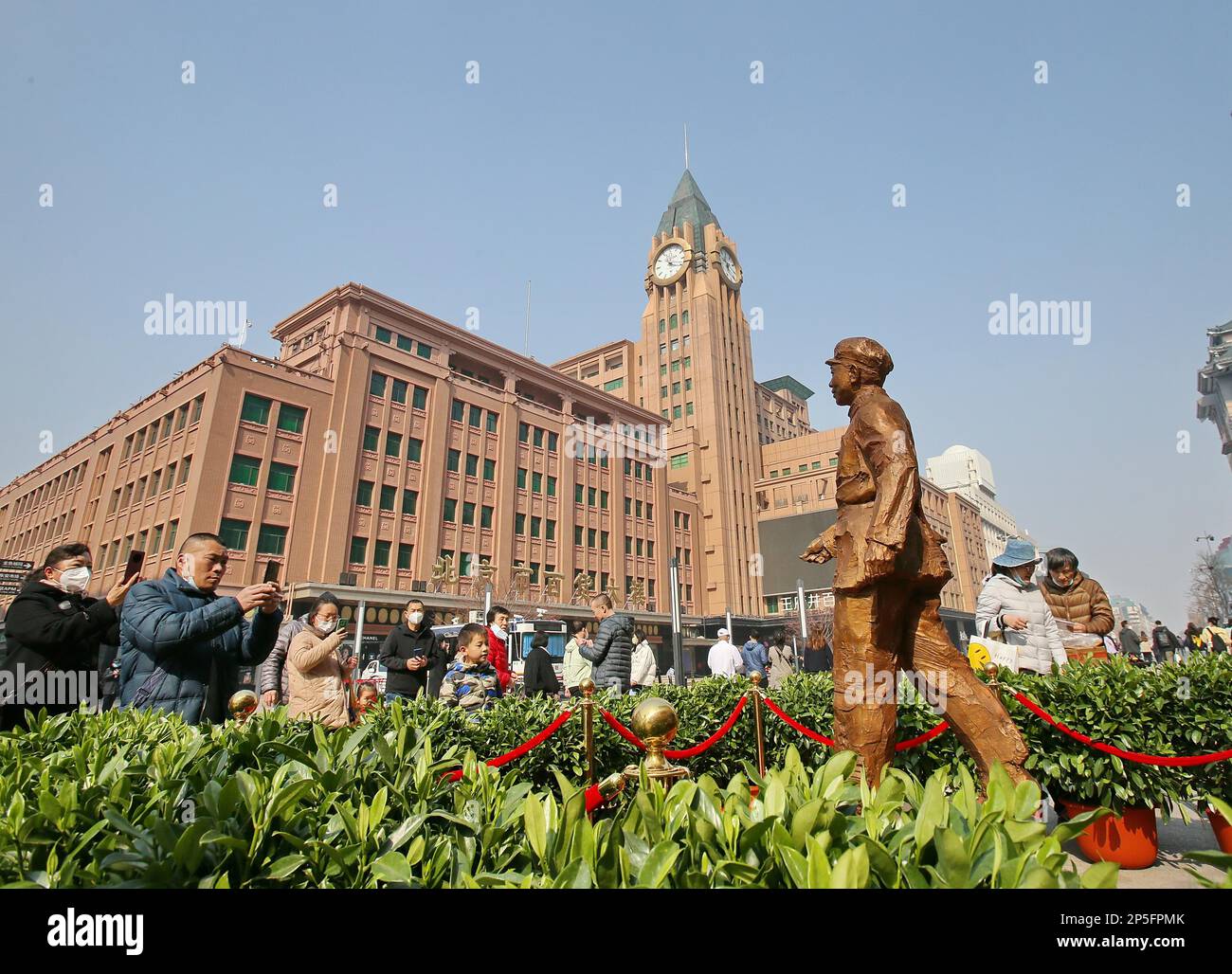 People take photos in front of the bronze statue of Lei Feng, a Chinese ...