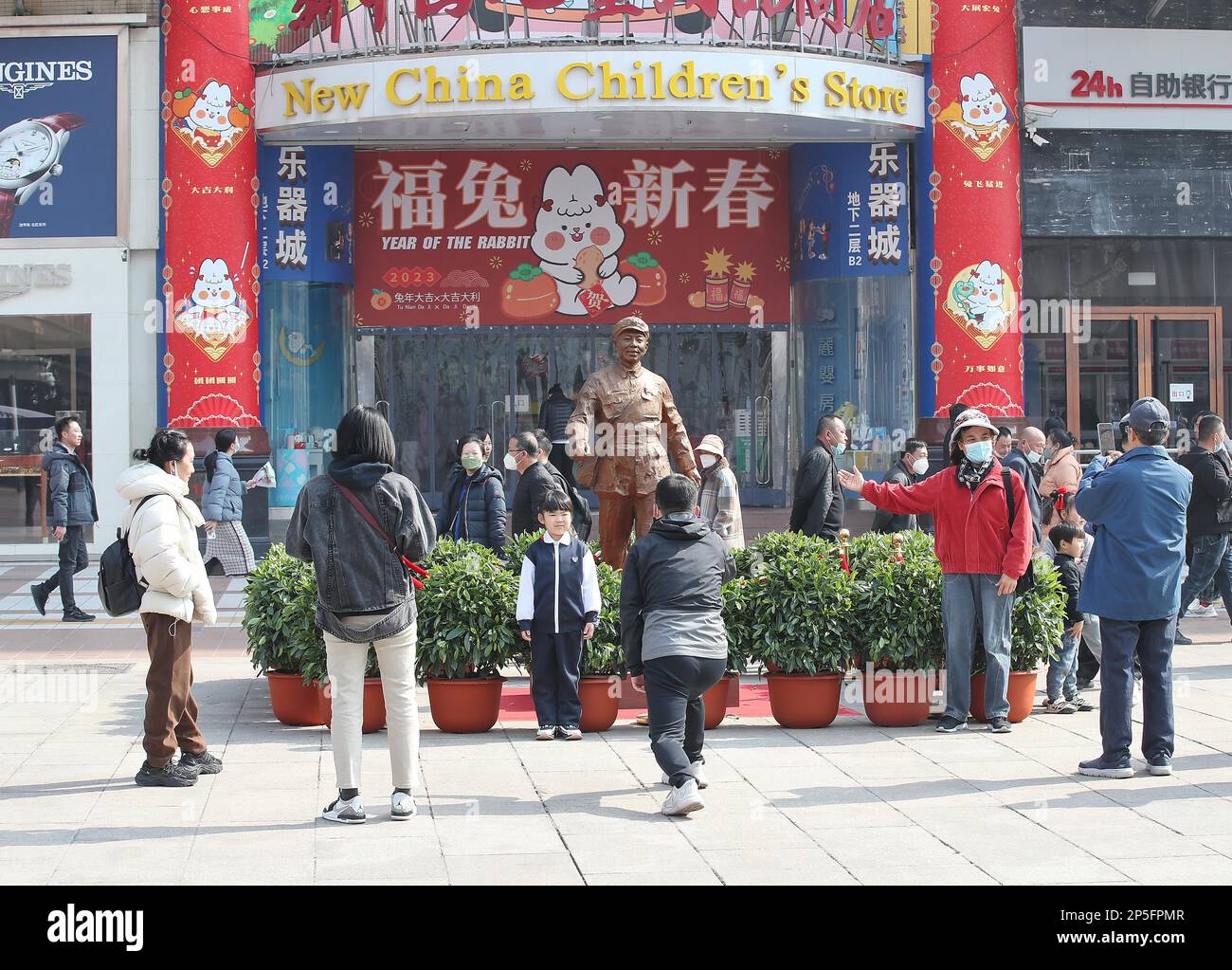 People take photos in front of the bronze statue of Lei Feng, a Chinese ...