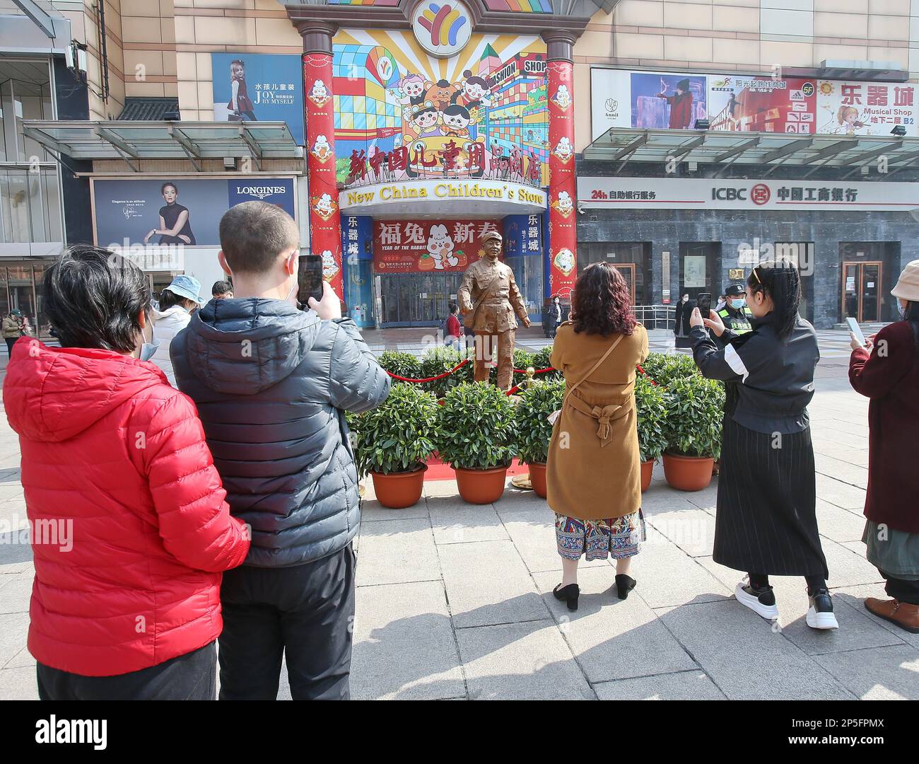 People take photos in front of the bronze statue of Lei Feng, a Chinese ...