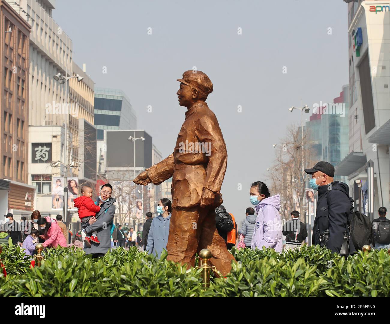 People take photos in front of the bronze statue of Lei Feng, a Chinese ...