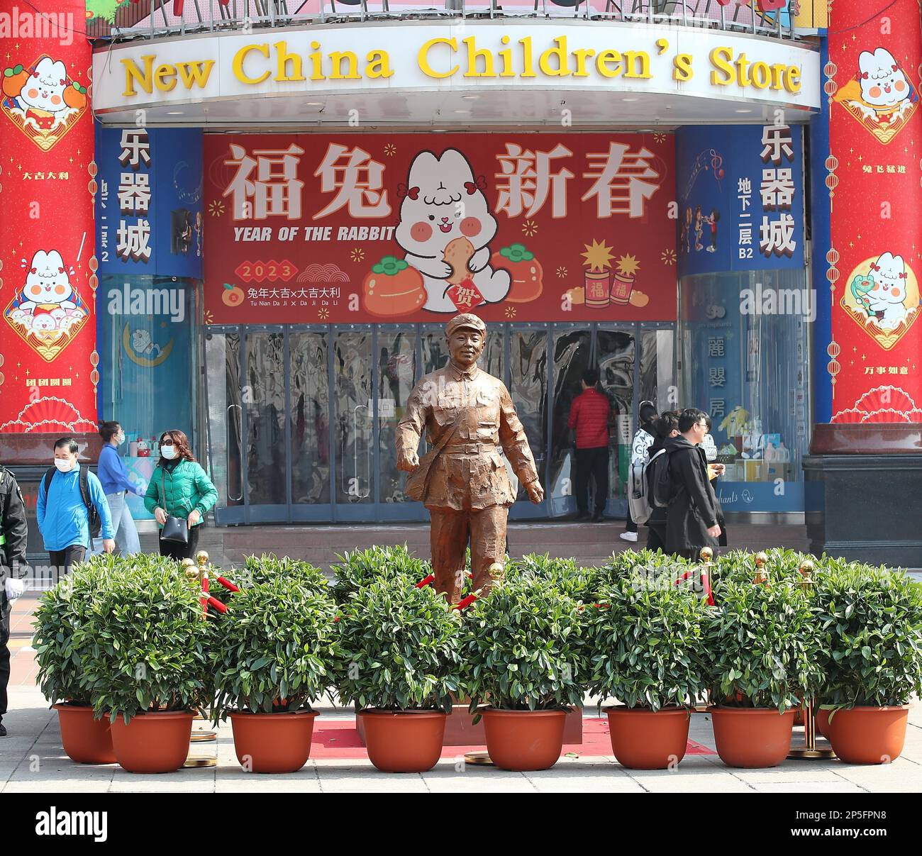 People take photos in front of the bronze statue of Lei Feng, a Chinese ...