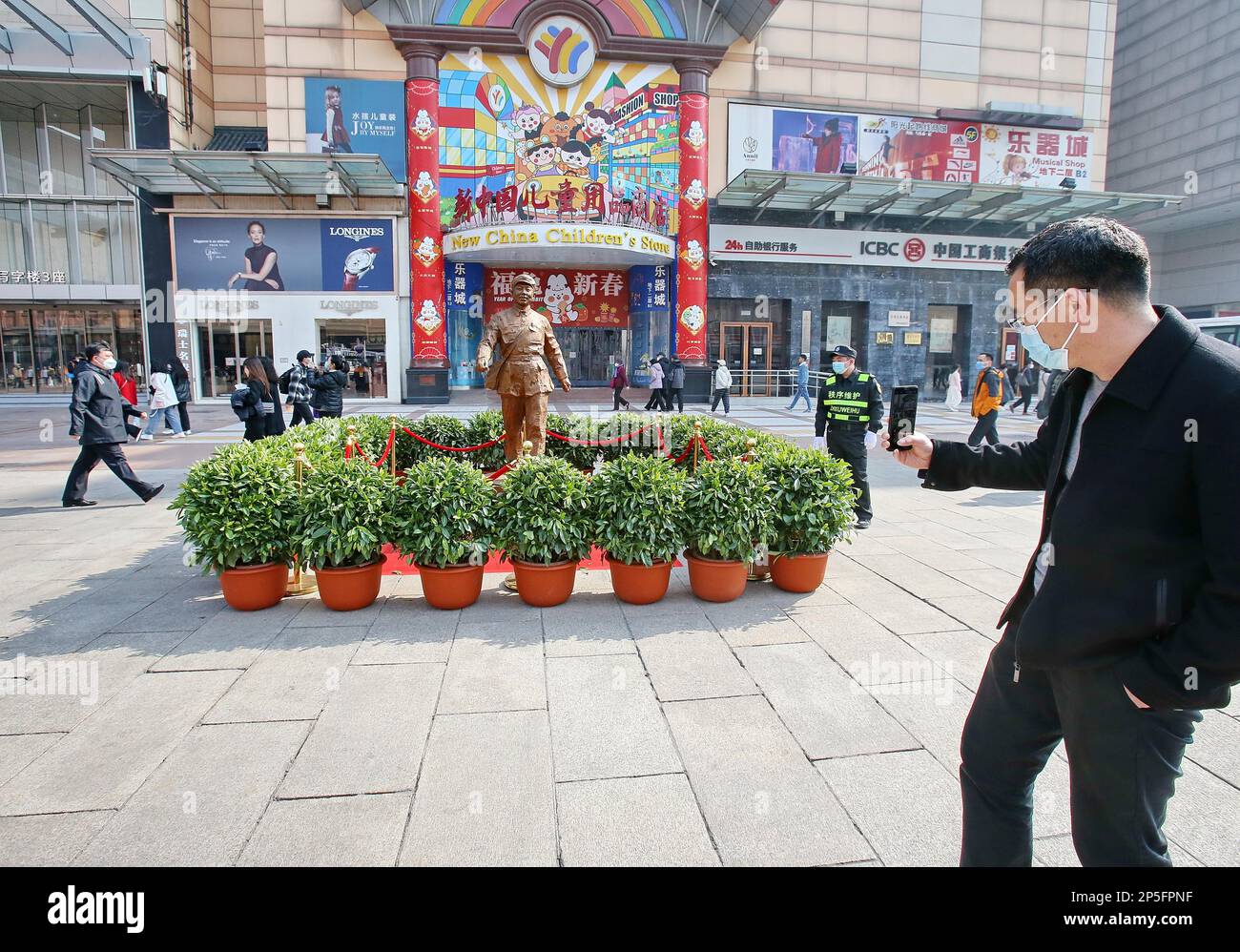 People take photos in front of the bronze statue of Lei Feng, a Chinese ...