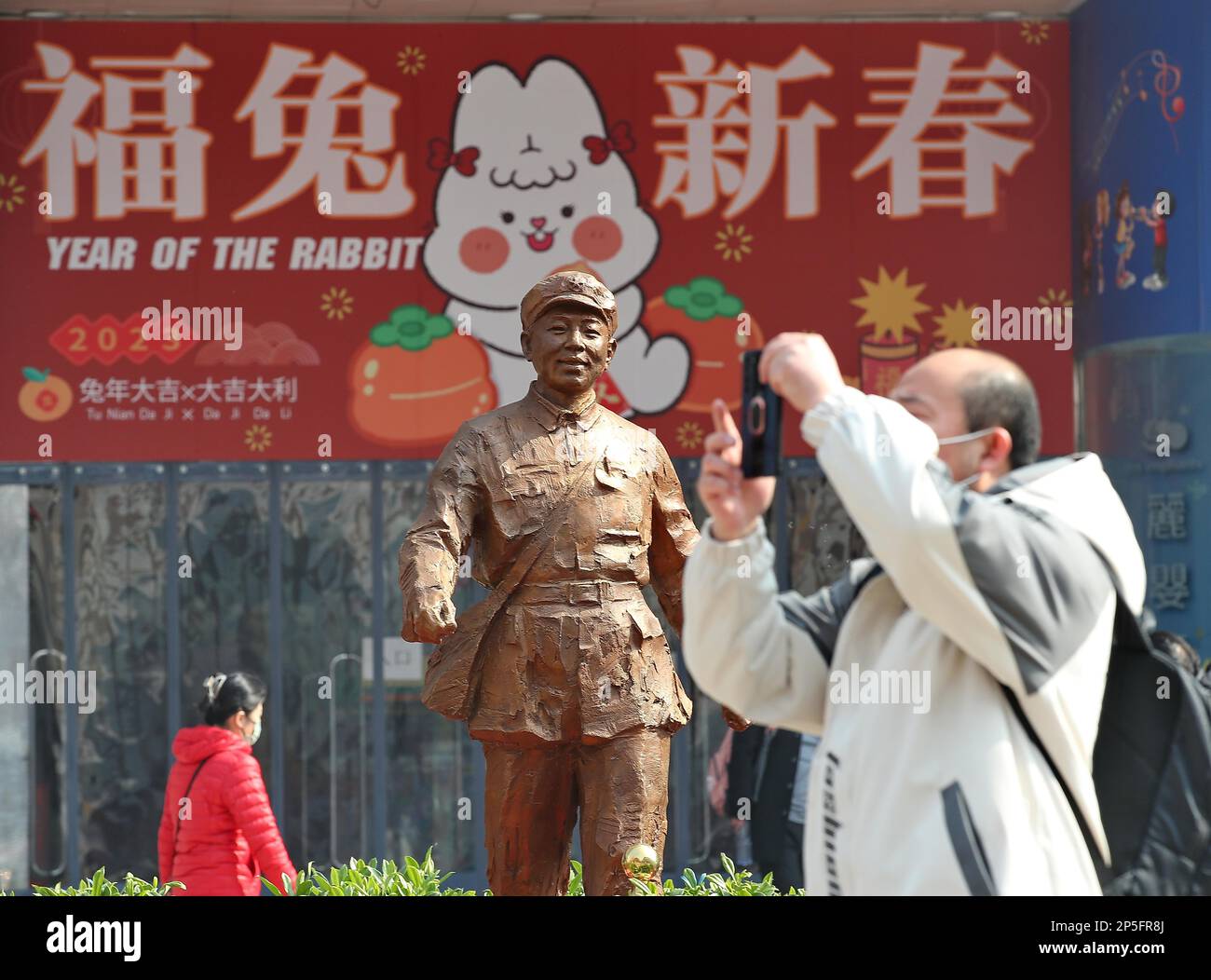 People take photos in front of the bronze statue of Lei Feng, a Chinese ...