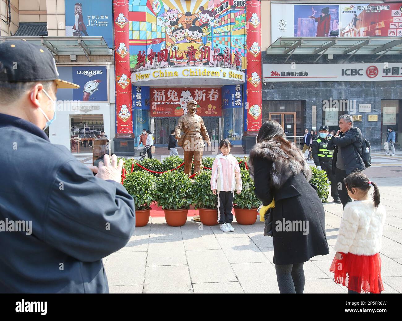 People take photos in front of the bronze statue of Lei Feng, a Chinese ...