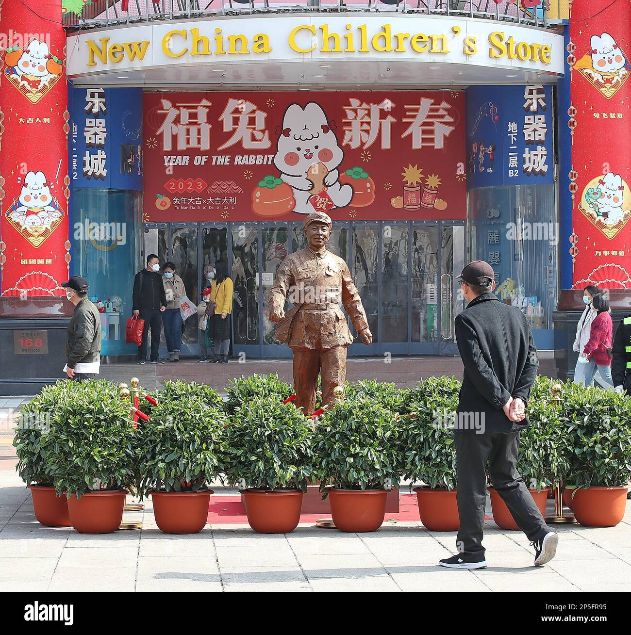 People take photos in front of the bronze statue of Lei Feng, a Chinese ...