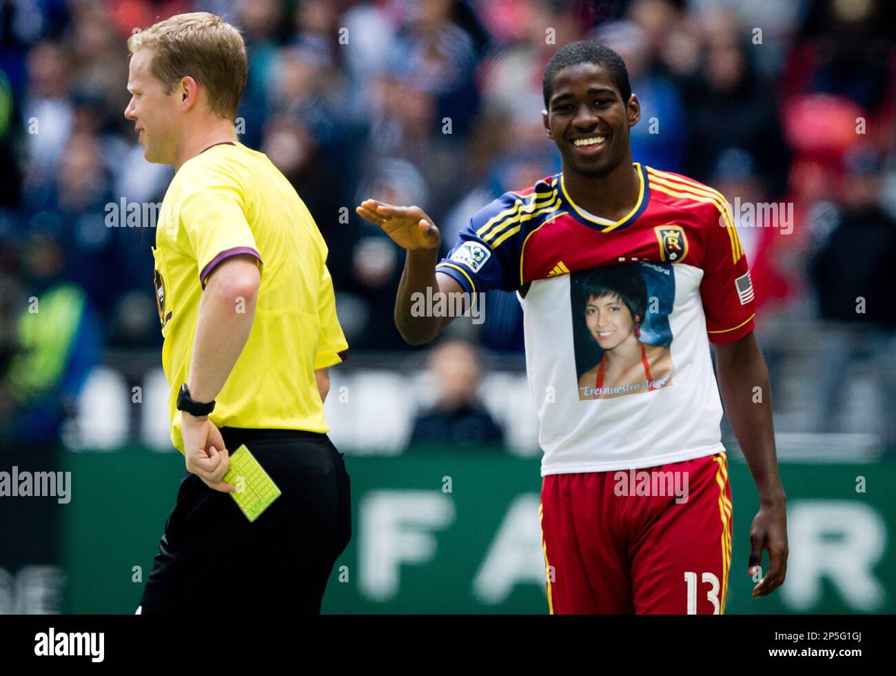 Real Salt Lake's Olmes Garcia, right, of Colombia, receives a yellow ...