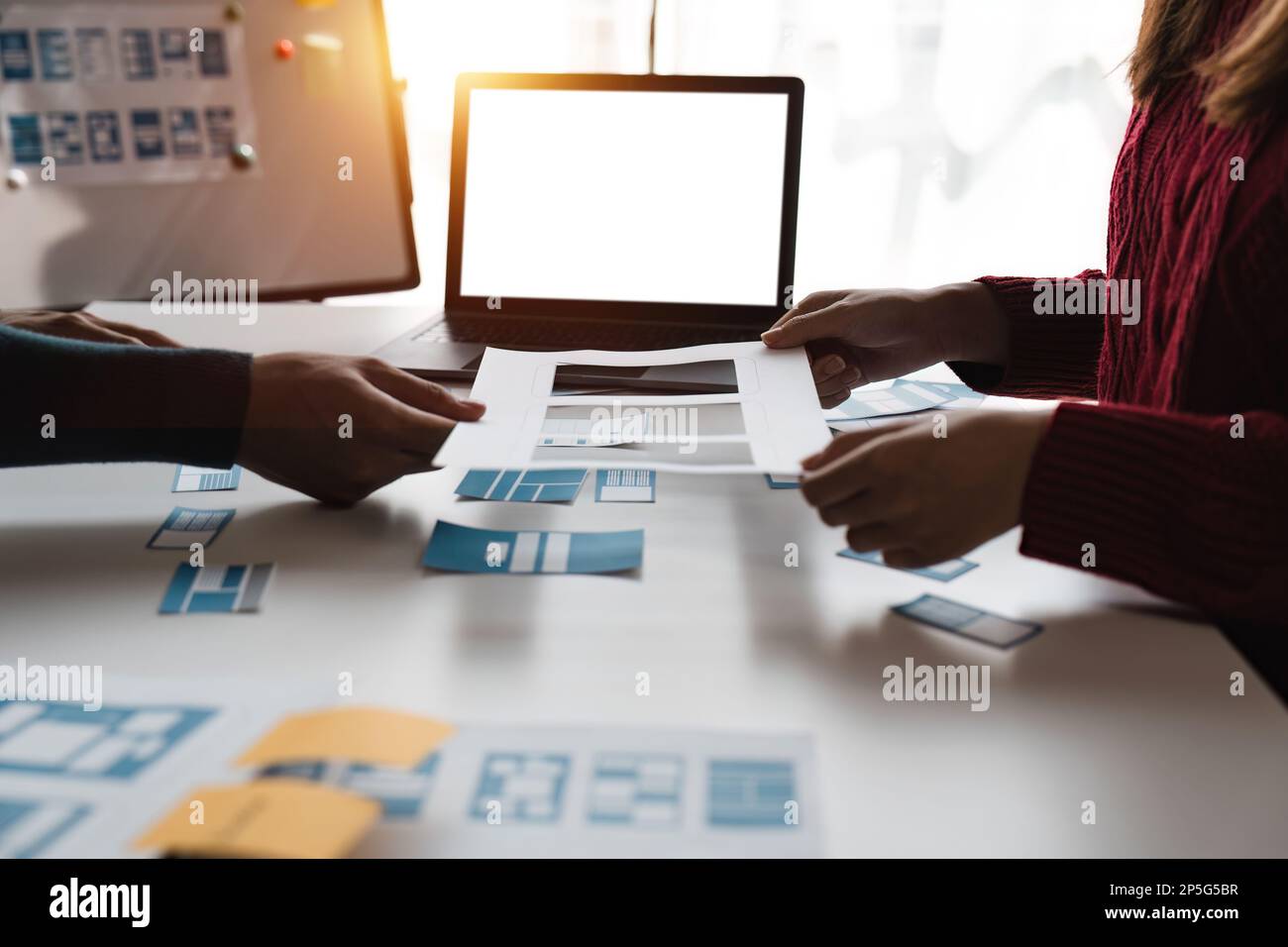 Close up ux developer and ui designer brainstorming about mobile app ...