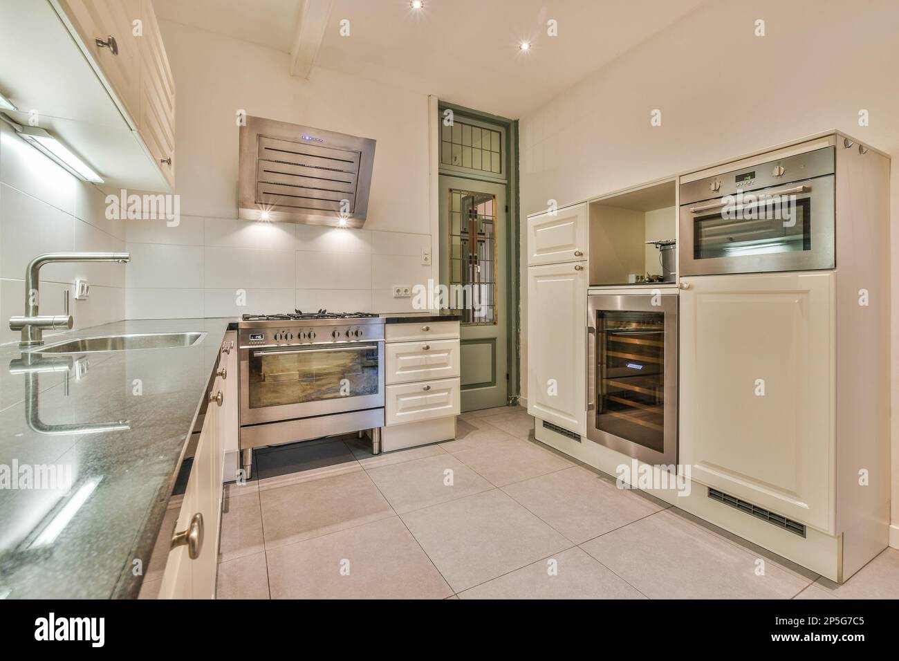 a kitchen area with an oven and stove in the middle of the room it is clean and ready for us to use Stock Photo Alamy