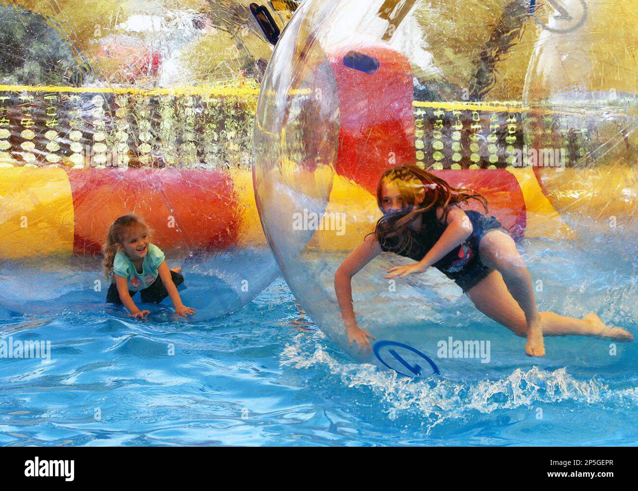 Ashley Burger, 4, left, and Kylie Straube, 9, experience “Ride the Orb ...