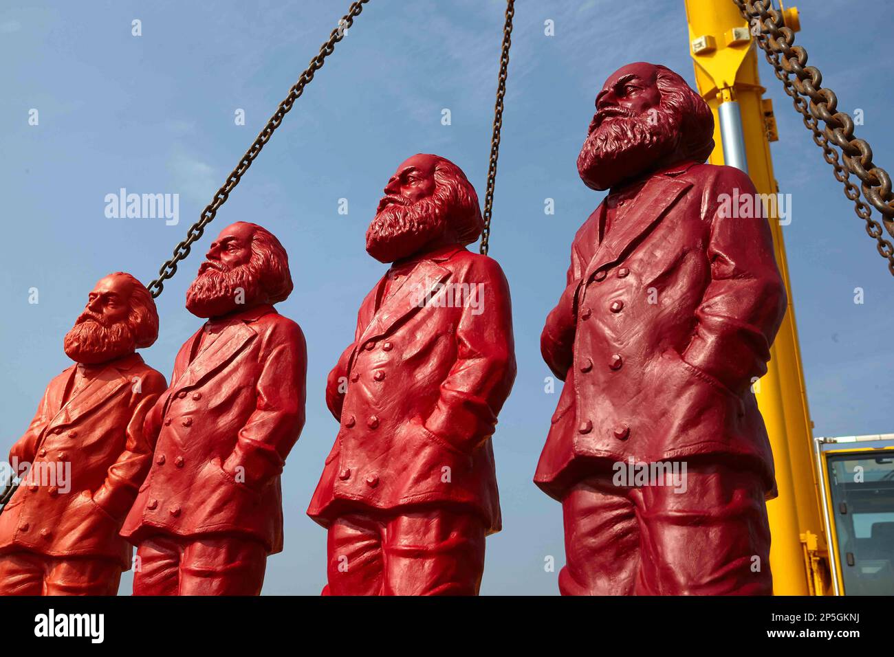 Red painted sculptures of Karl Marx , German philosopher and ...