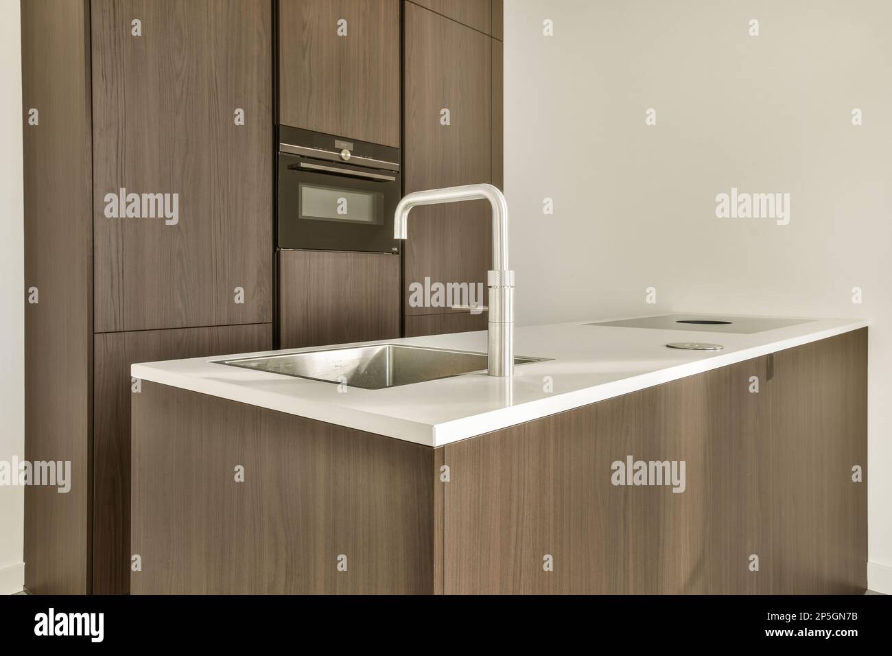 a modern kitchen with white counter tops and dark wood cabinets in the ...