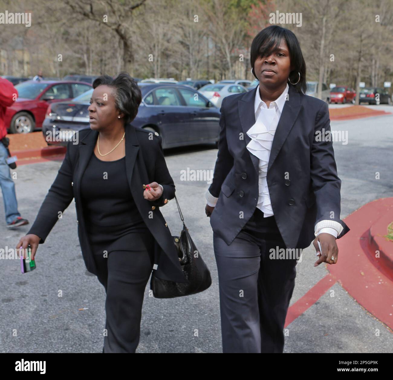 From left, Attorney Robbin Shipp walks with her client APS educator ...