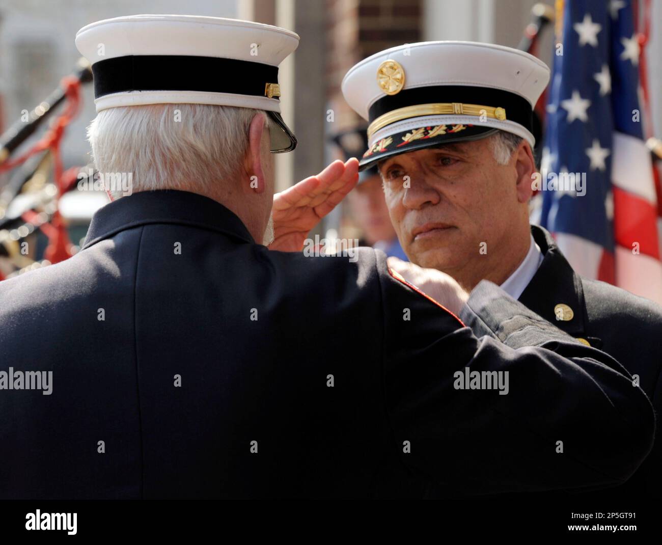 New London, Conn., Fire Department Chief Henry Kydd, right, salutes his ...