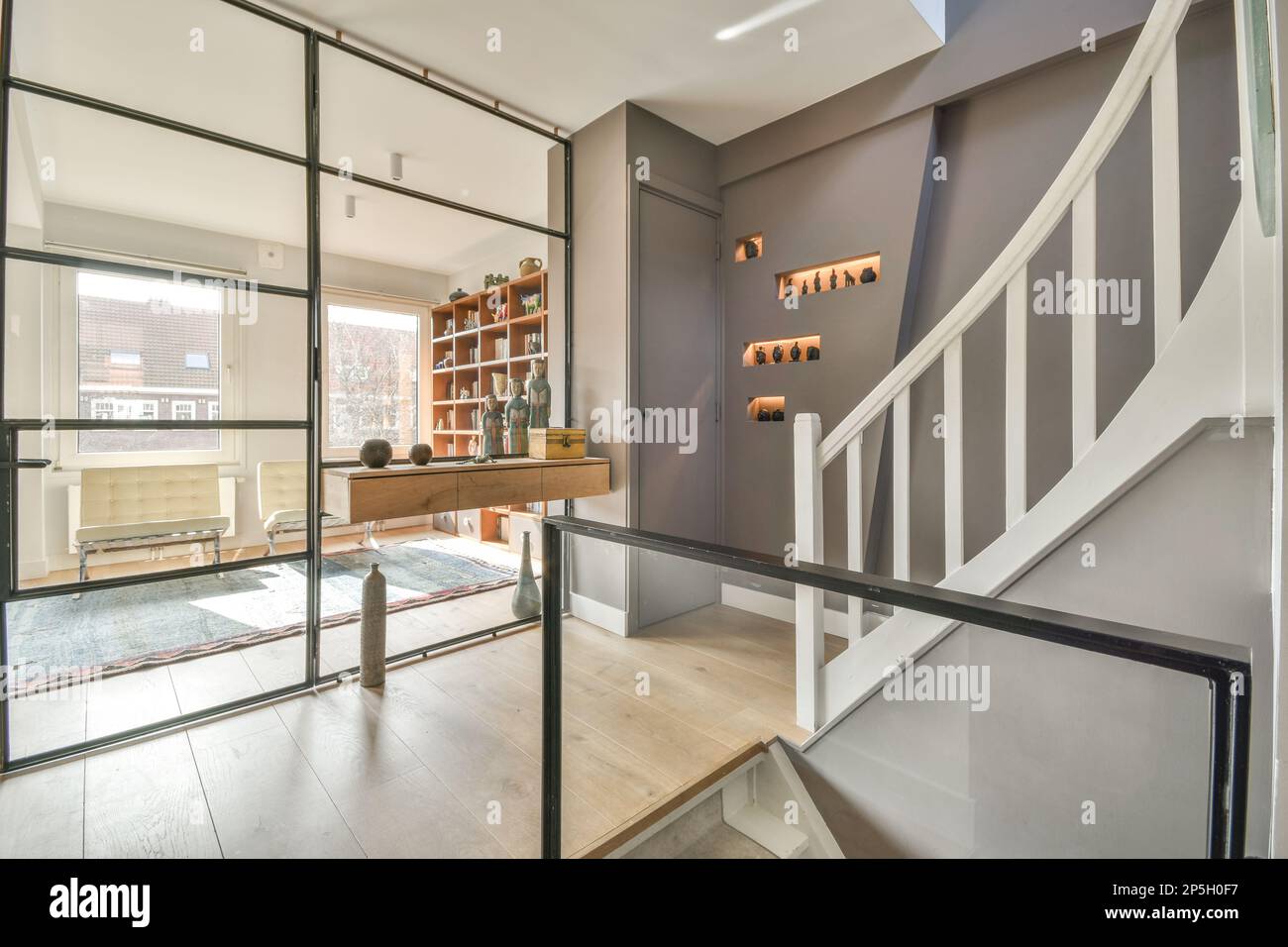 a living room with stairs leading up to the second floor and an open ...