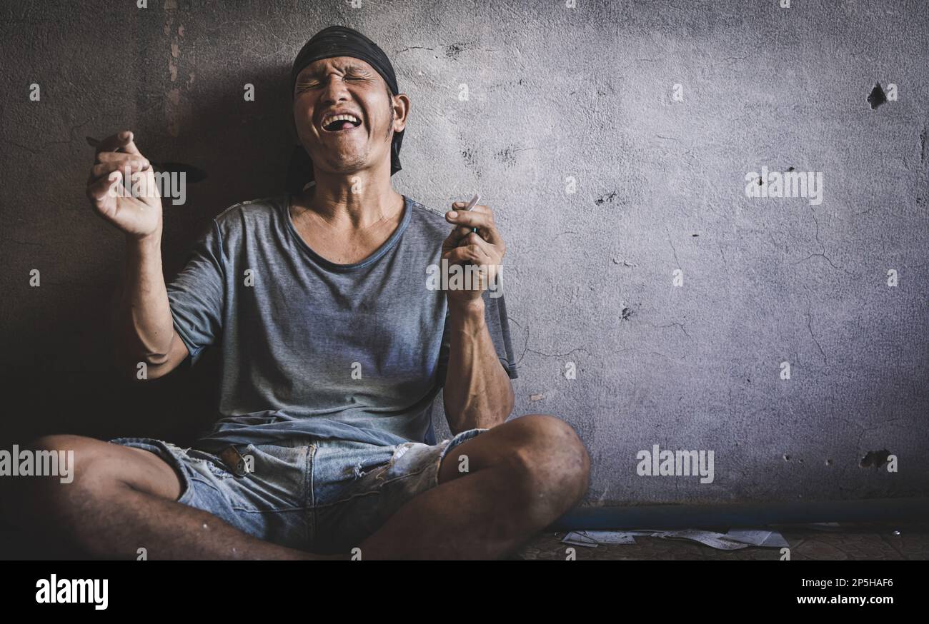 Addictive concept of man sitting and carrying his bag of heroin. Self ...