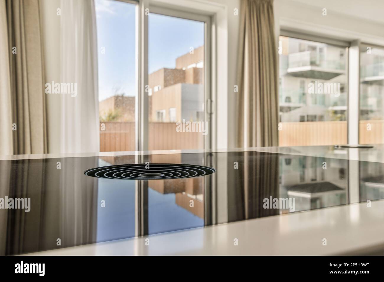 a kitchen counter with a stove in front of it and an outside view ...
