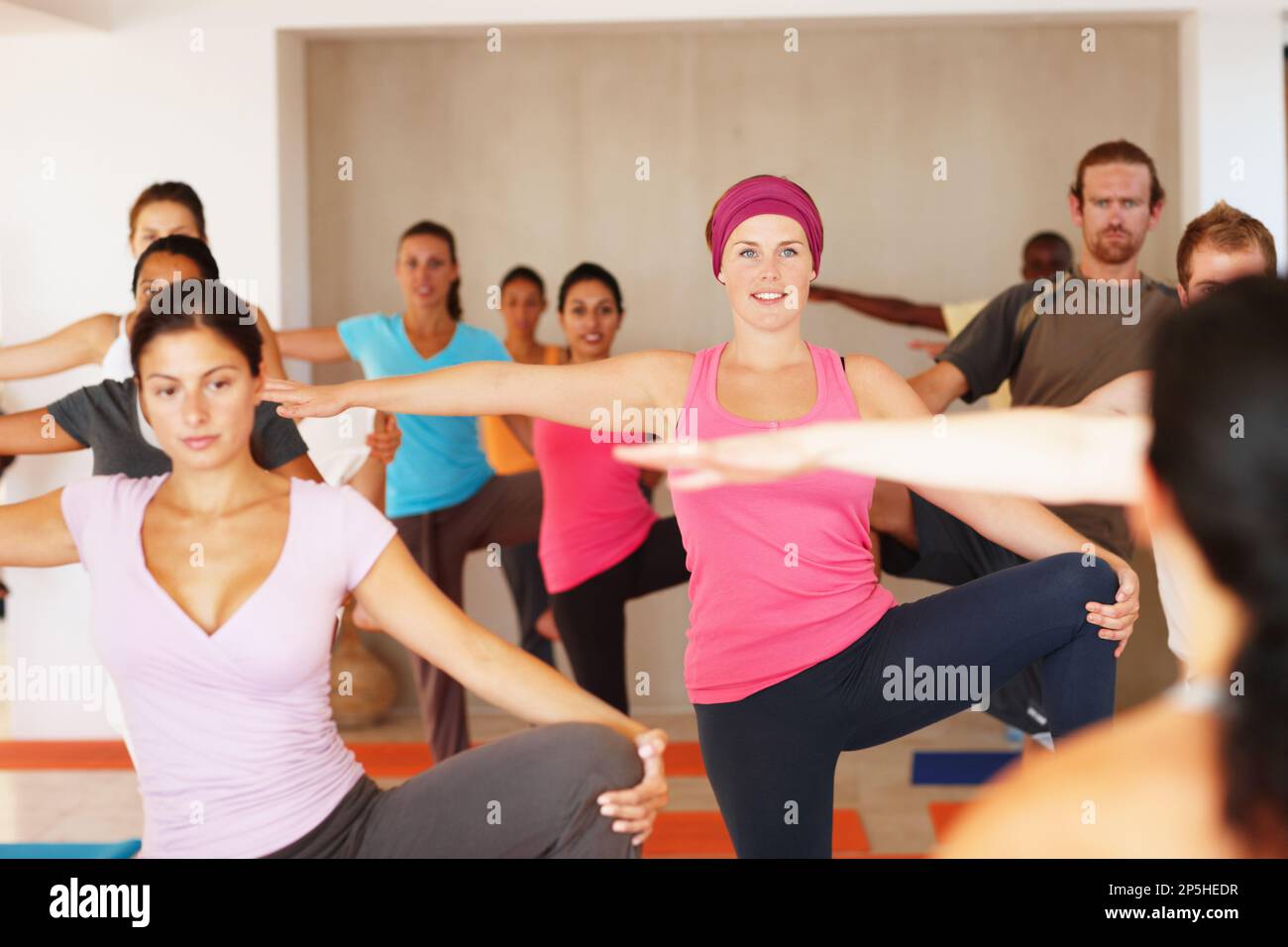 Focusing on the proper stance. Rearview cropped shot of a yoga ...
