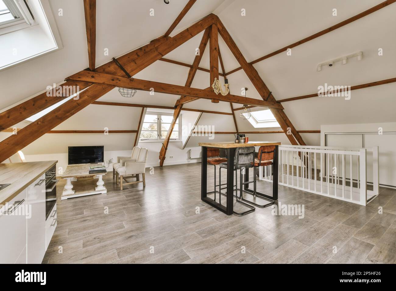 a kitchen and dining area in an attic style home with wood beams on the ...