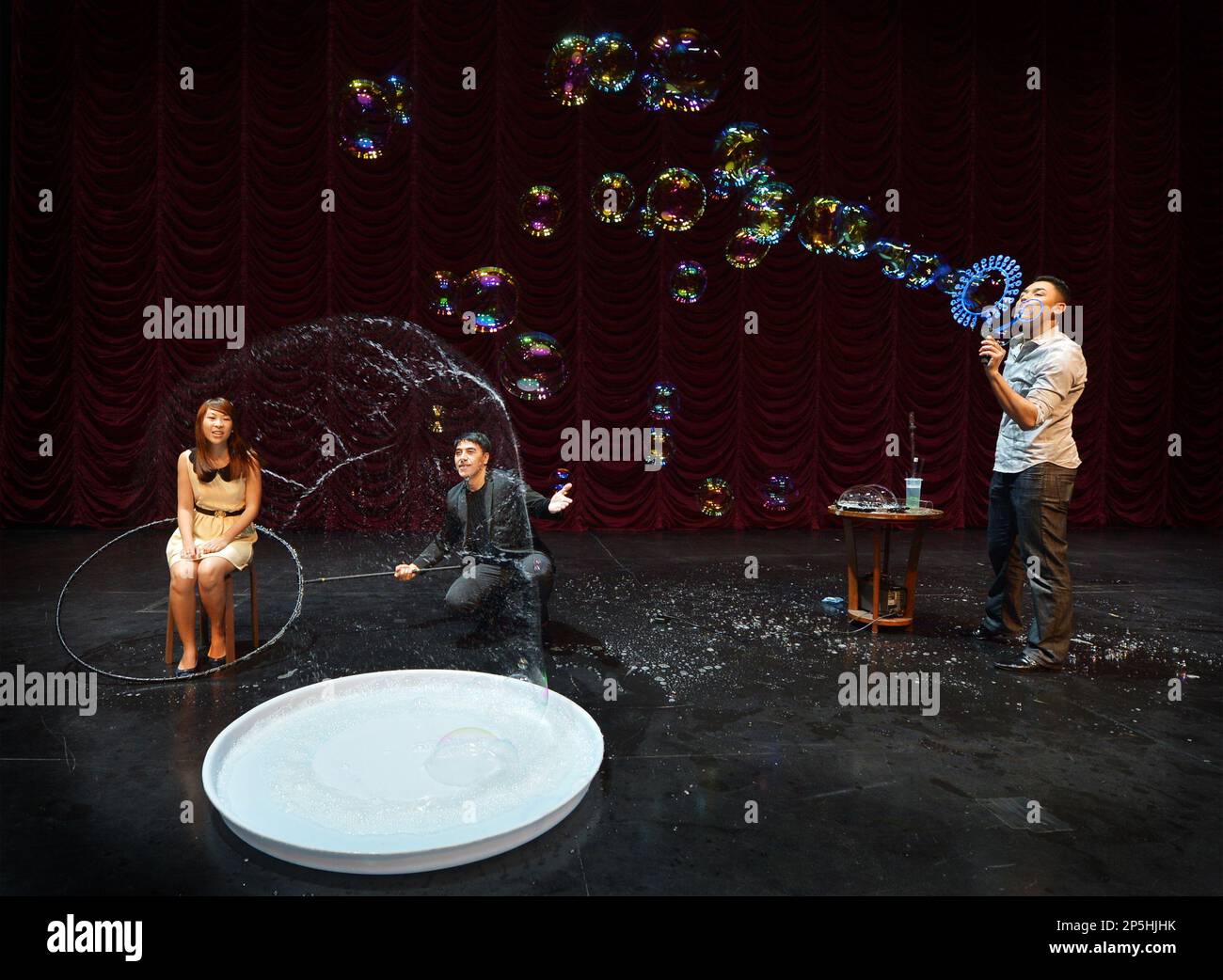 Deni Yang (R), bubble artist and son of the famed Fan Yang (centre) who ...