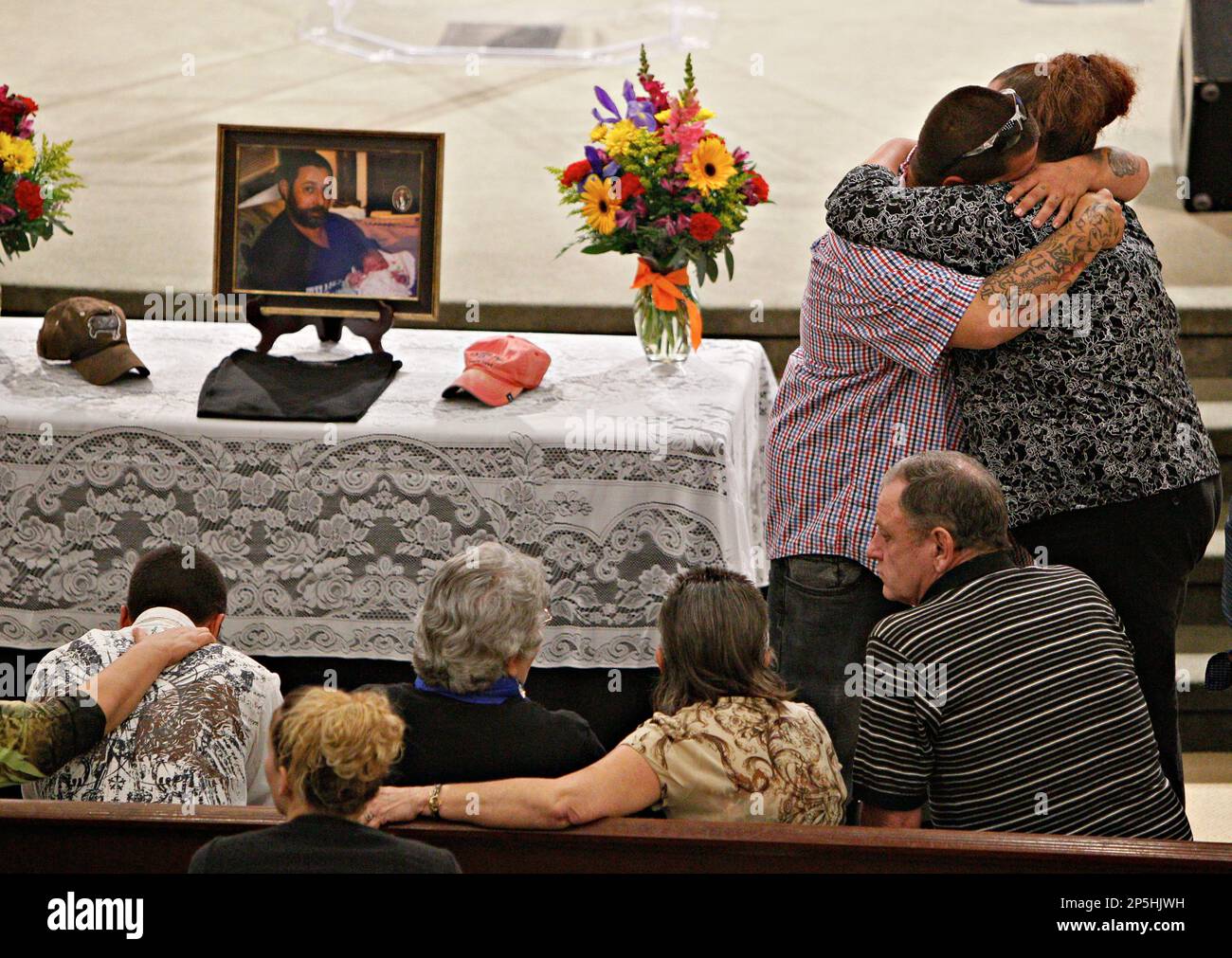 Jeremy Bush hugs his fiance Rachel Wicker, right, as other friends and ...