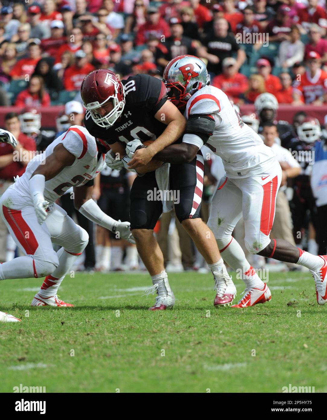Temple University Owls quarterback Chris Coyer (10) tries to get away ...