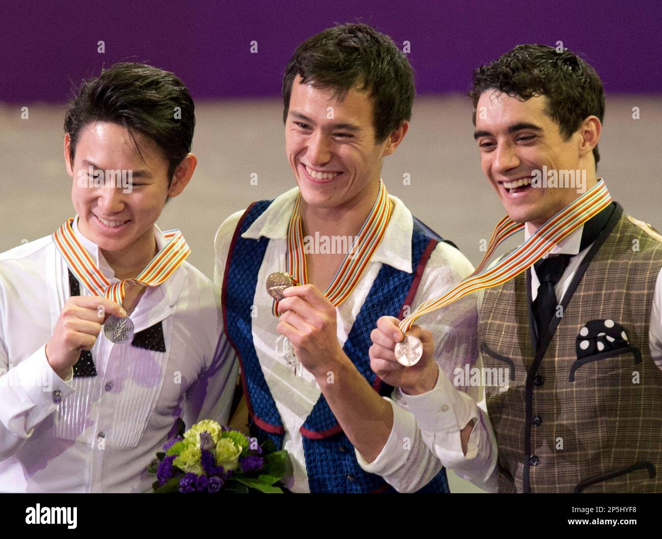 Gold medalist Patrick Chan, center, of Canada, flanked by silver ...