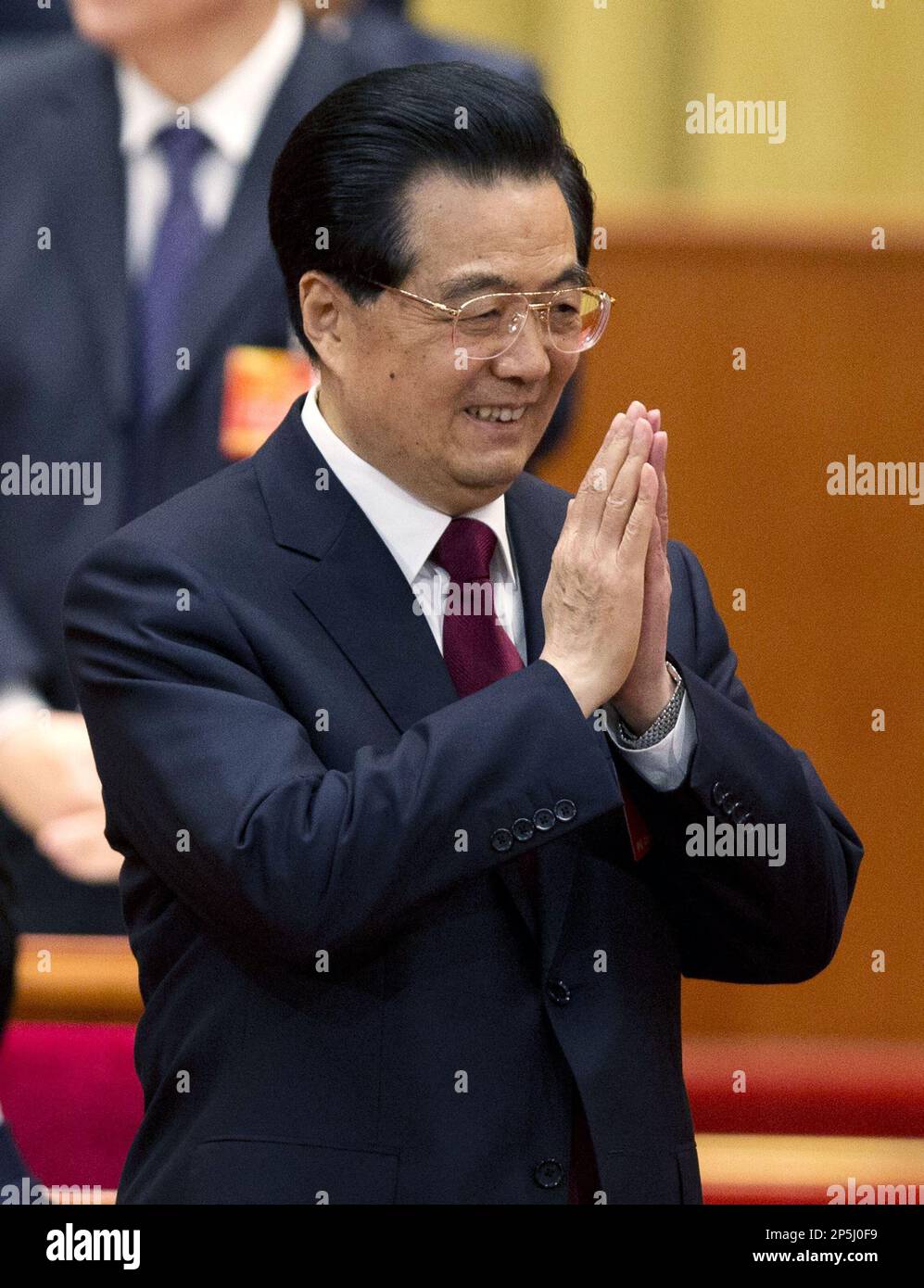 Former Chinese President Hu Jintao greets delegates during the 12th ...
