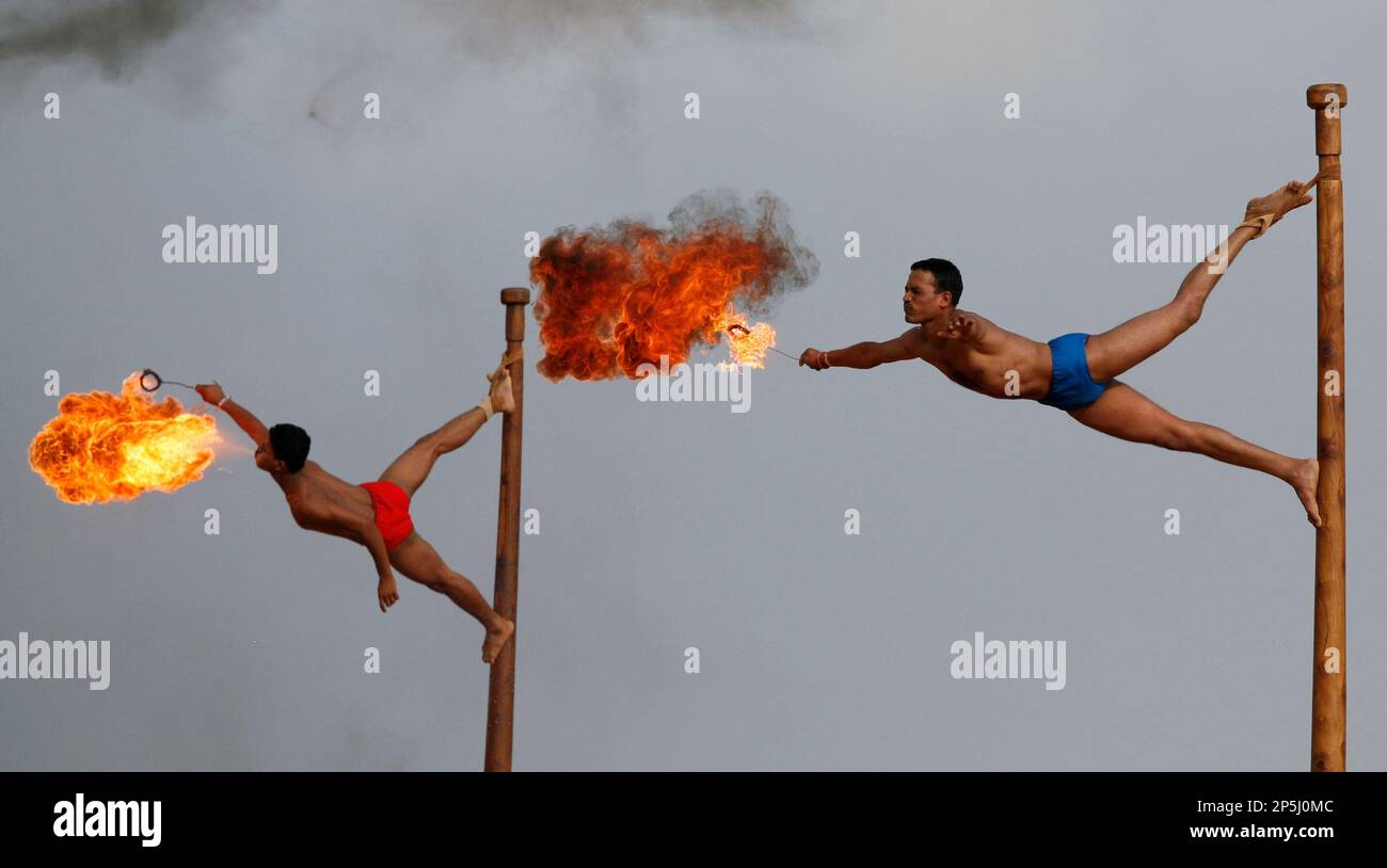 Indian army soldiers spit fire as they perform the mallakhamb, a ...