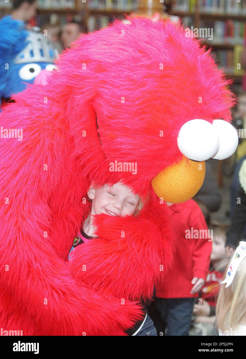 Four year old Parker Cave gets consumed by a big hug from Elmo at the ...
