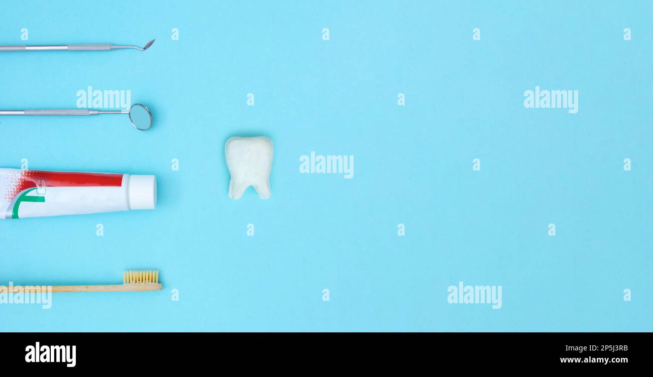 Basic dentist tools , toothbrush, toothpaste and Tooth model on blue ...