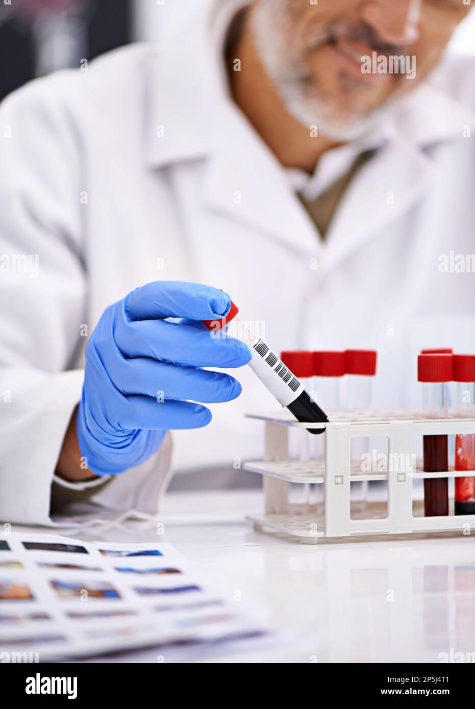 This specimen holds the key. a male scientist conducting blood tests in ...