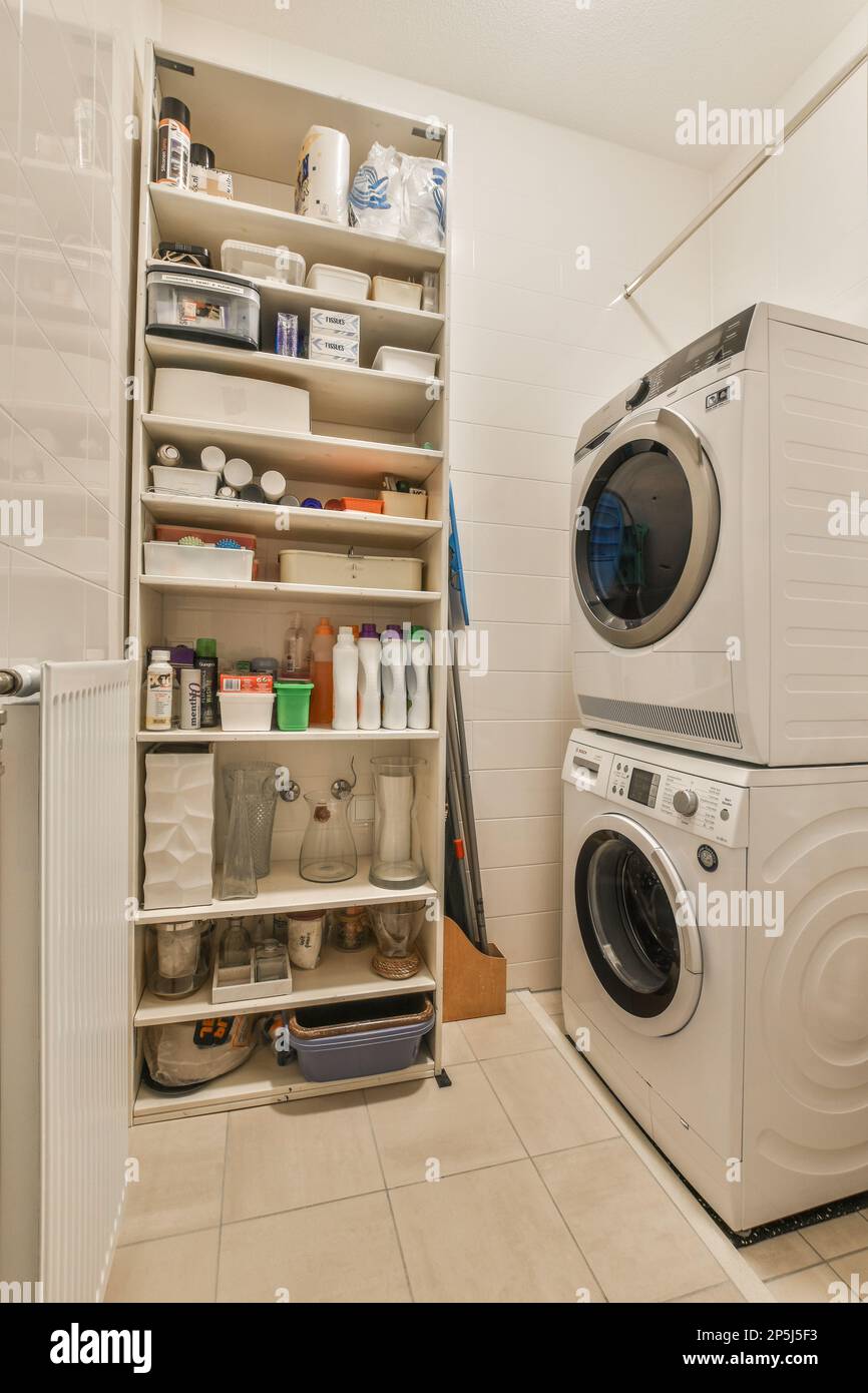 a laundry room with a washer, dryer and other items on the floor in ...