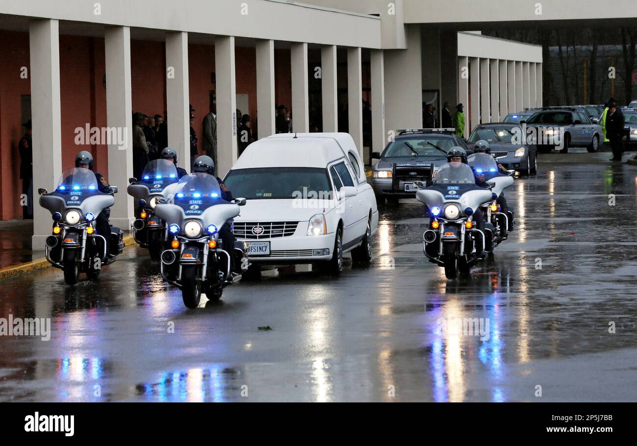 A Virginia State Trooper motorcade escorts the hearse carrying the body ...