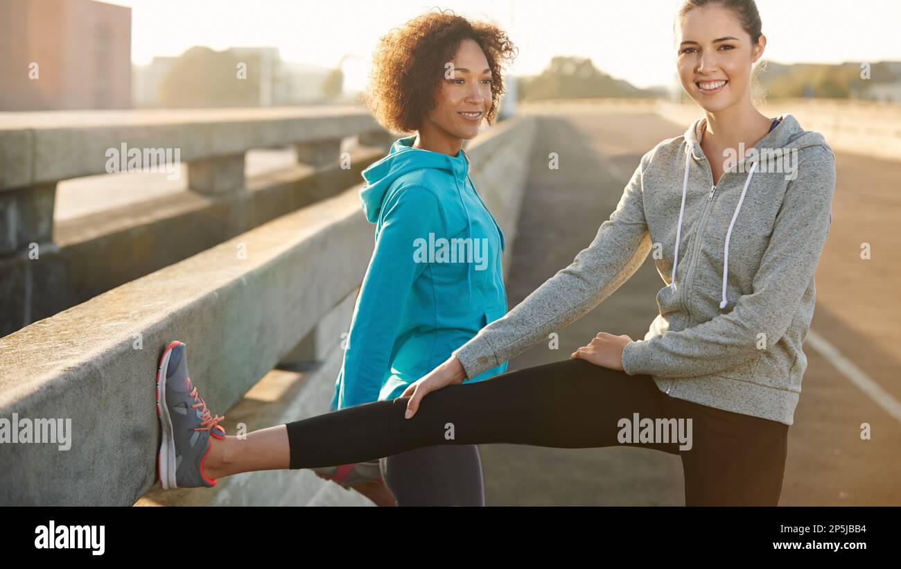 Its hard exercise but we love it. Portrait of two friends stretching ...