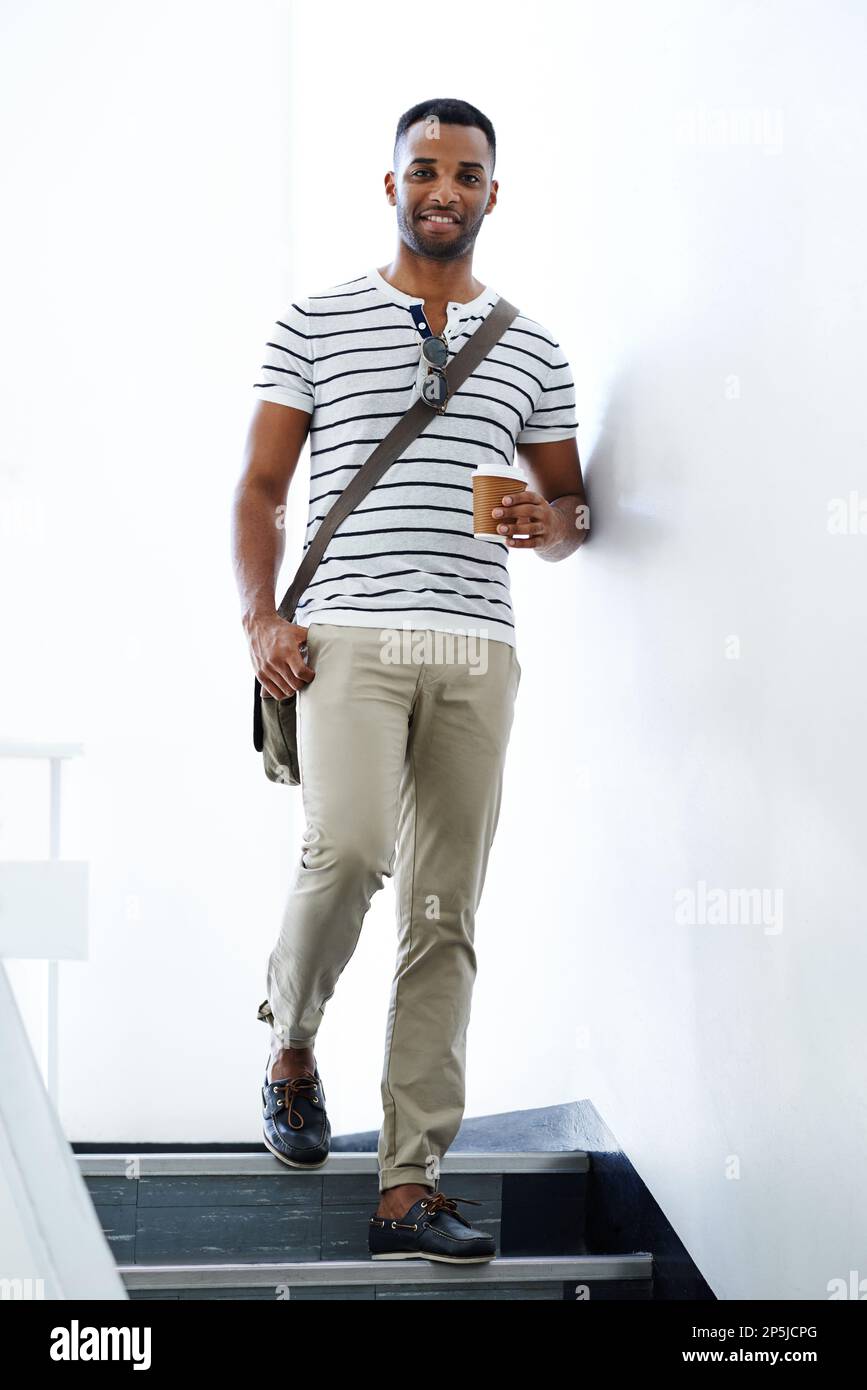 Heading to an informal meeting. A stylish, casually attired young businessman walking down the ...