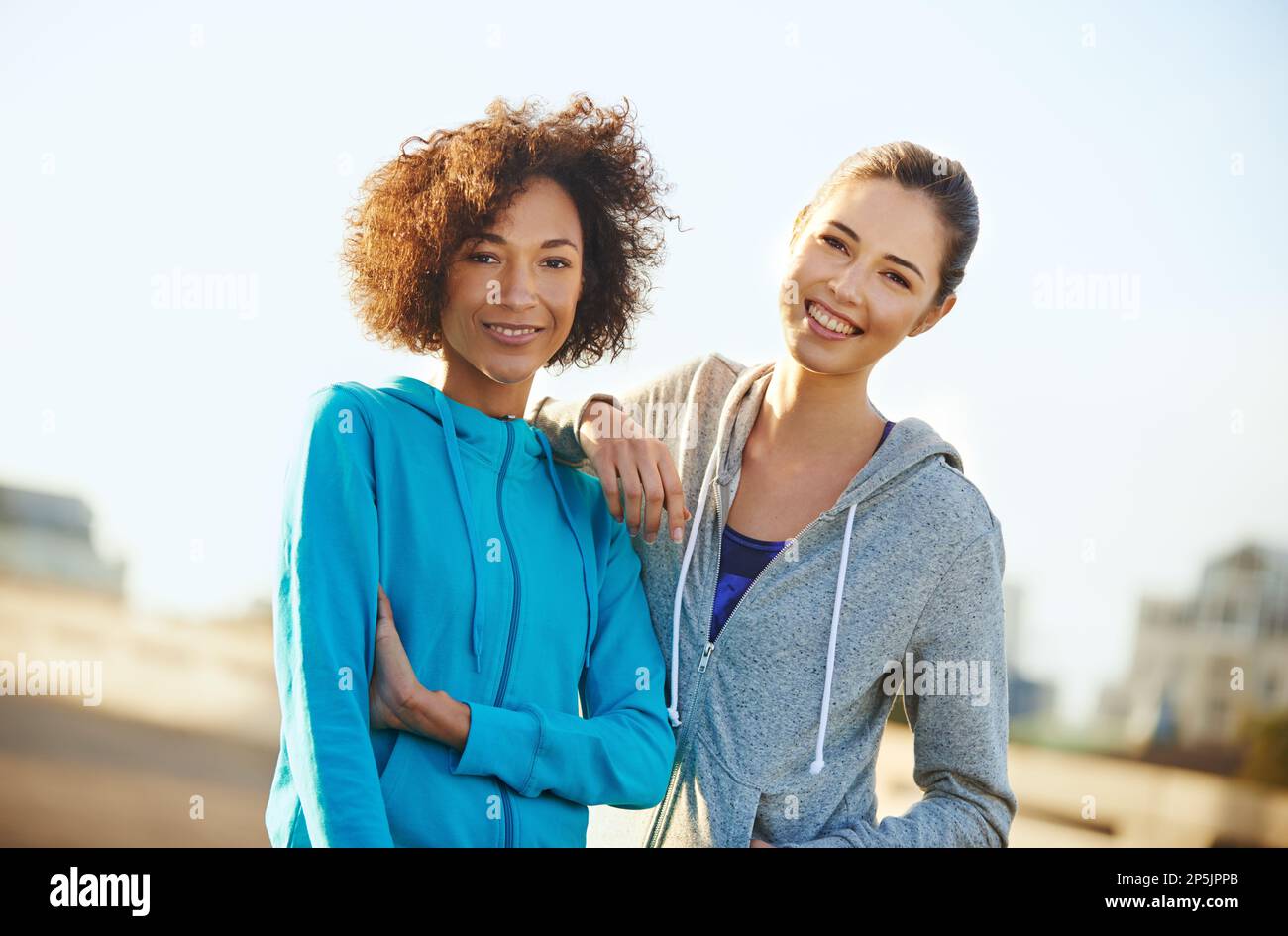 We just beat our best running record. Portrait of two female joggers ...