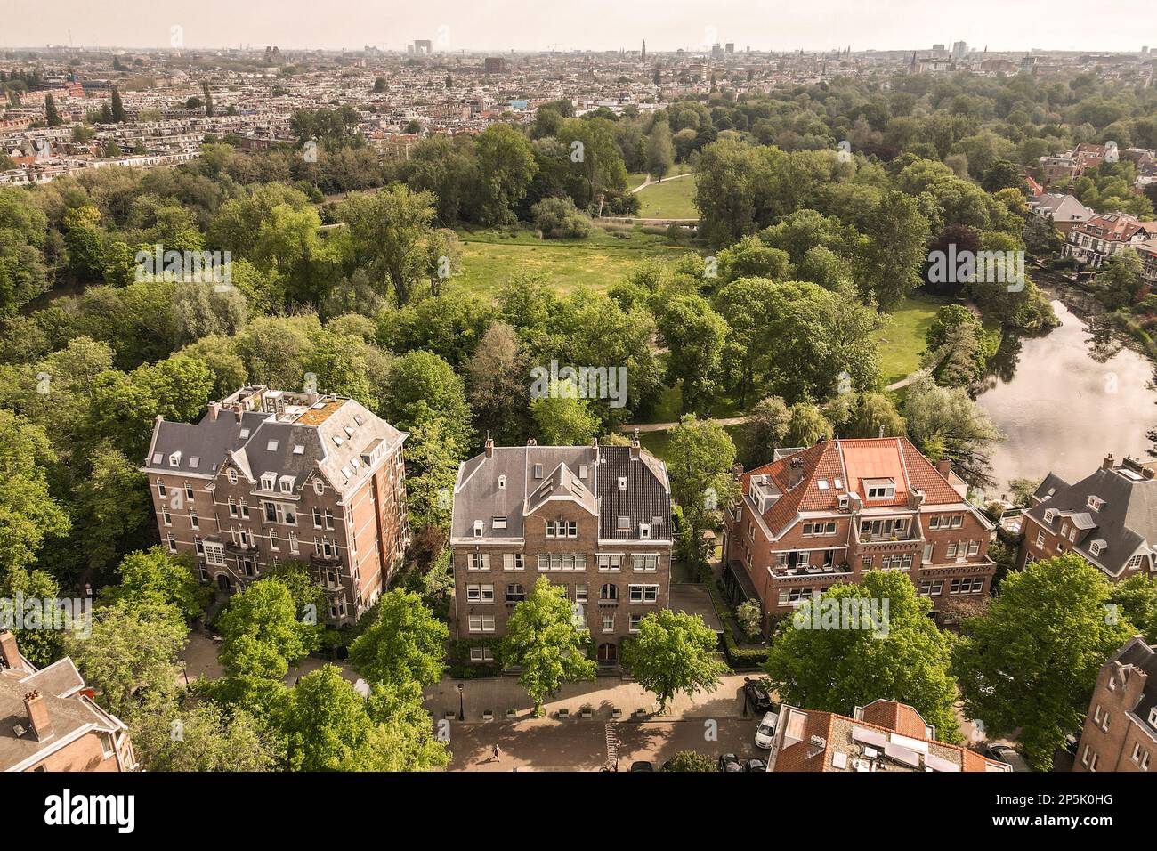 an aerial view of some houses and trees in the distance, taken from a ...