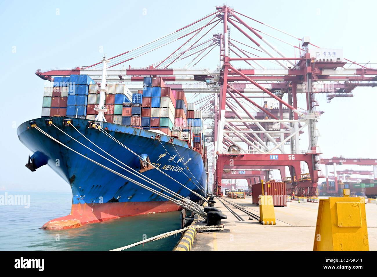 QINGDAO, CHINA - MARCH 7, 2023 - Cargo ships load and unload containers ...
