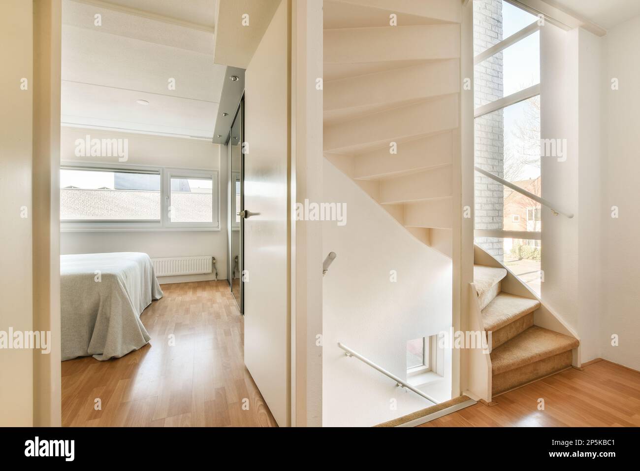 the inside of a house with wood flooring and stairs leading up to an open door that leads to a ...