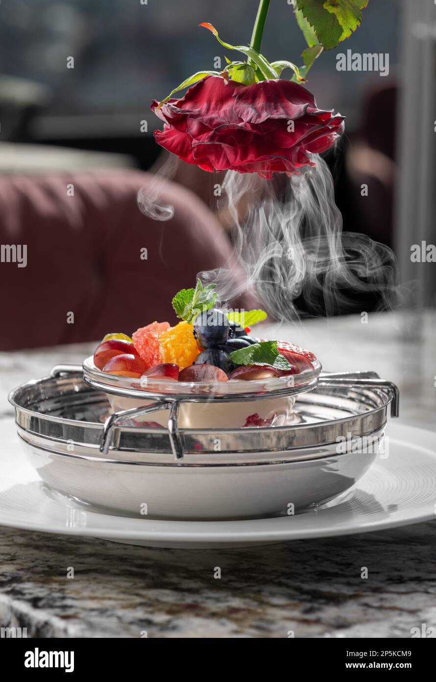 Ice cream dessert with berries and rose petals frozen in nitrogen ...