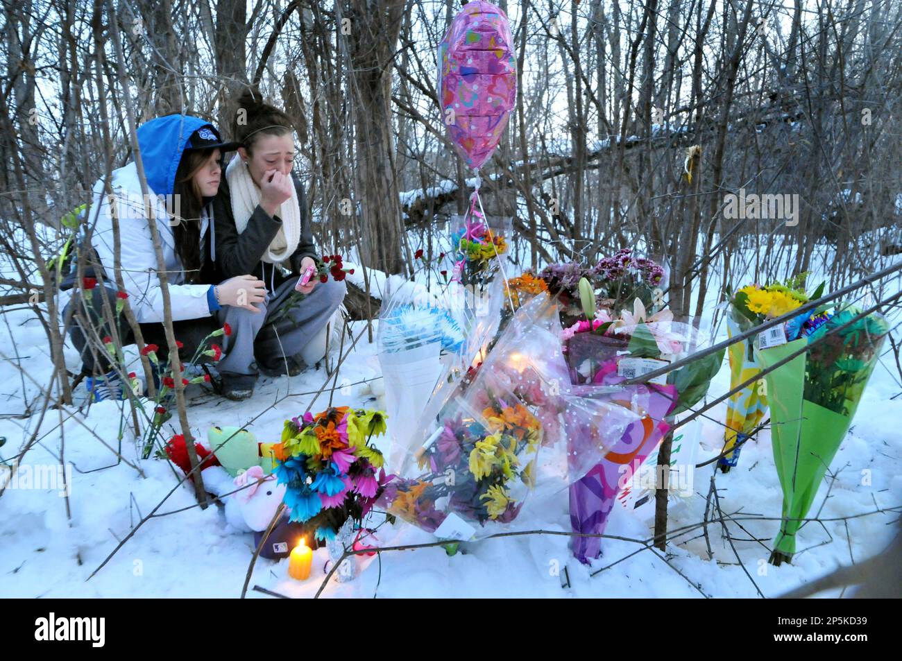Emily Wilson, 16, left, consoles Danielle Wilhelm, 17, as they view a ...