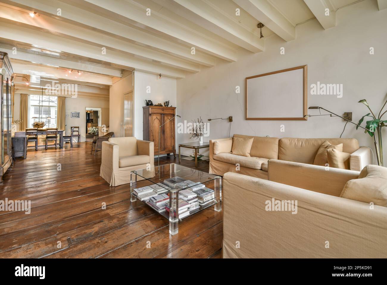 a living room with wood flooring and exposed beams on the ceiling above ...